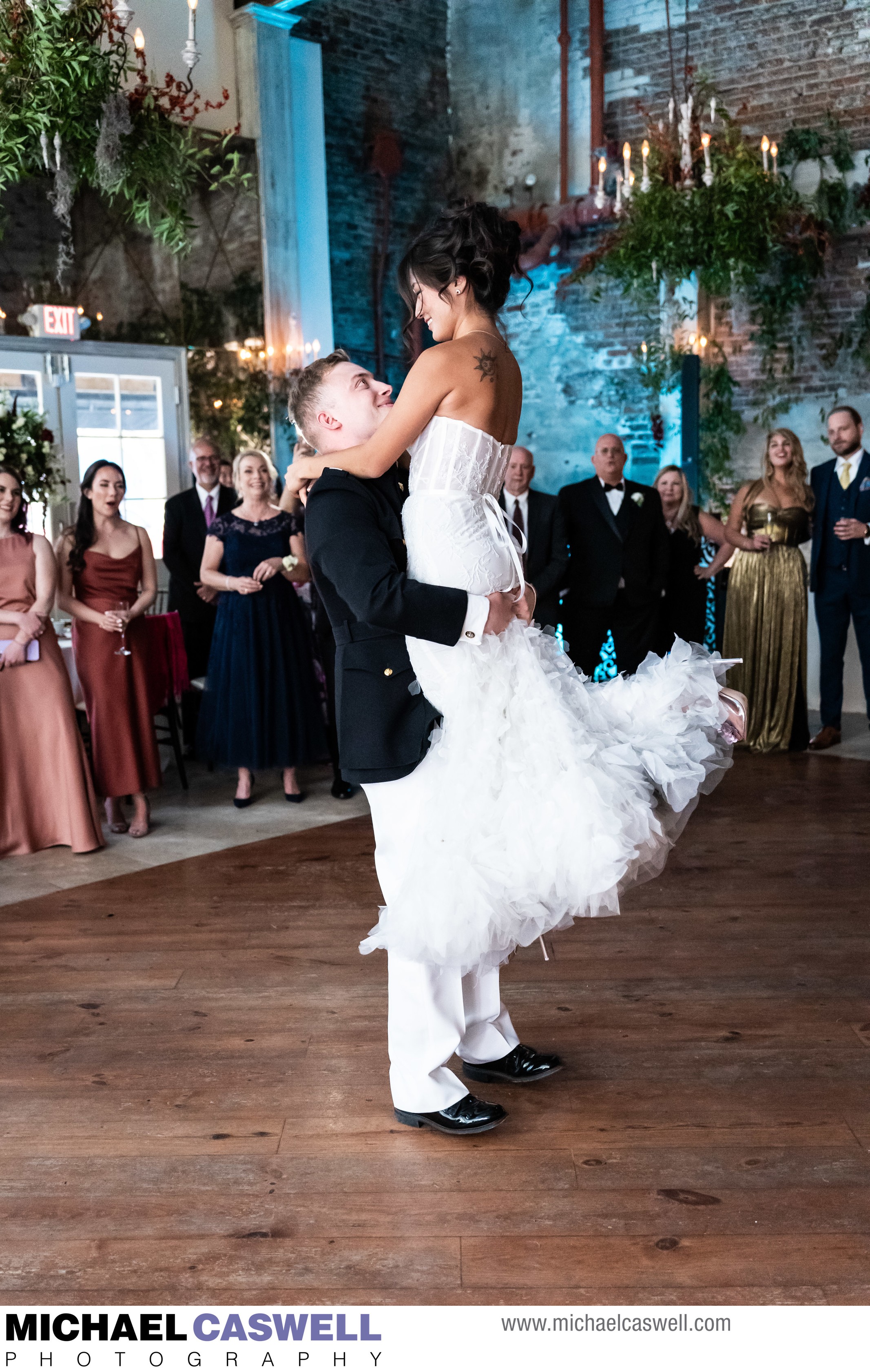 Groom lifts bride at Gallery Venue at Tomas Wedding